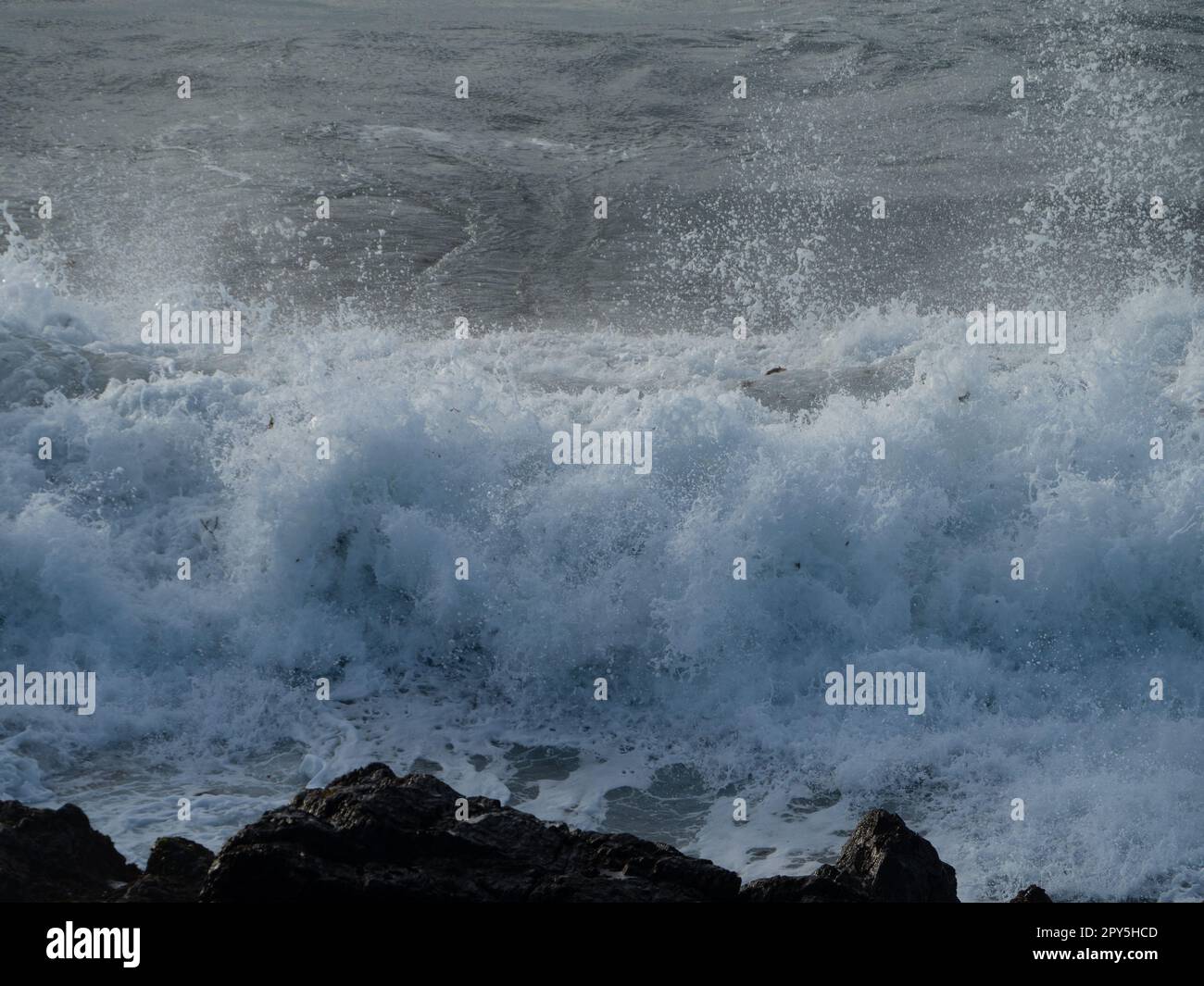 Water splashing up, sea waves crashing into rocks, seaweed and other ...