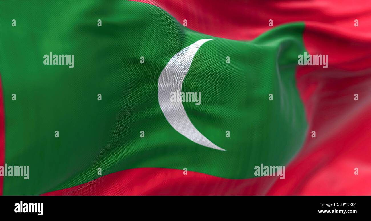 Detail of the Maldives national flag fluttering. Flag is a green ...