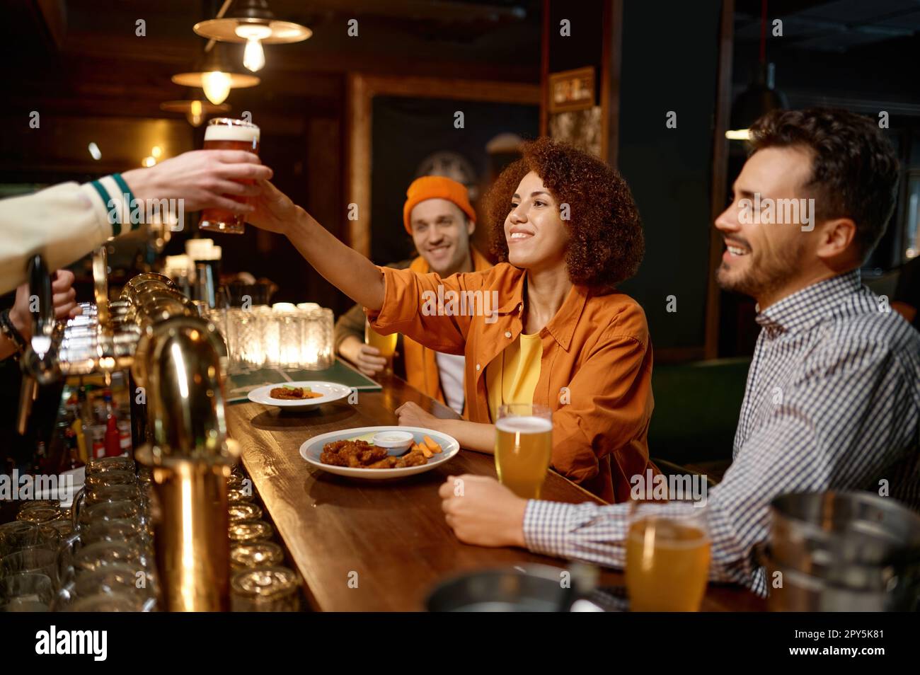 Happy friends company rest in sports bar together Stock Photo - Alamy