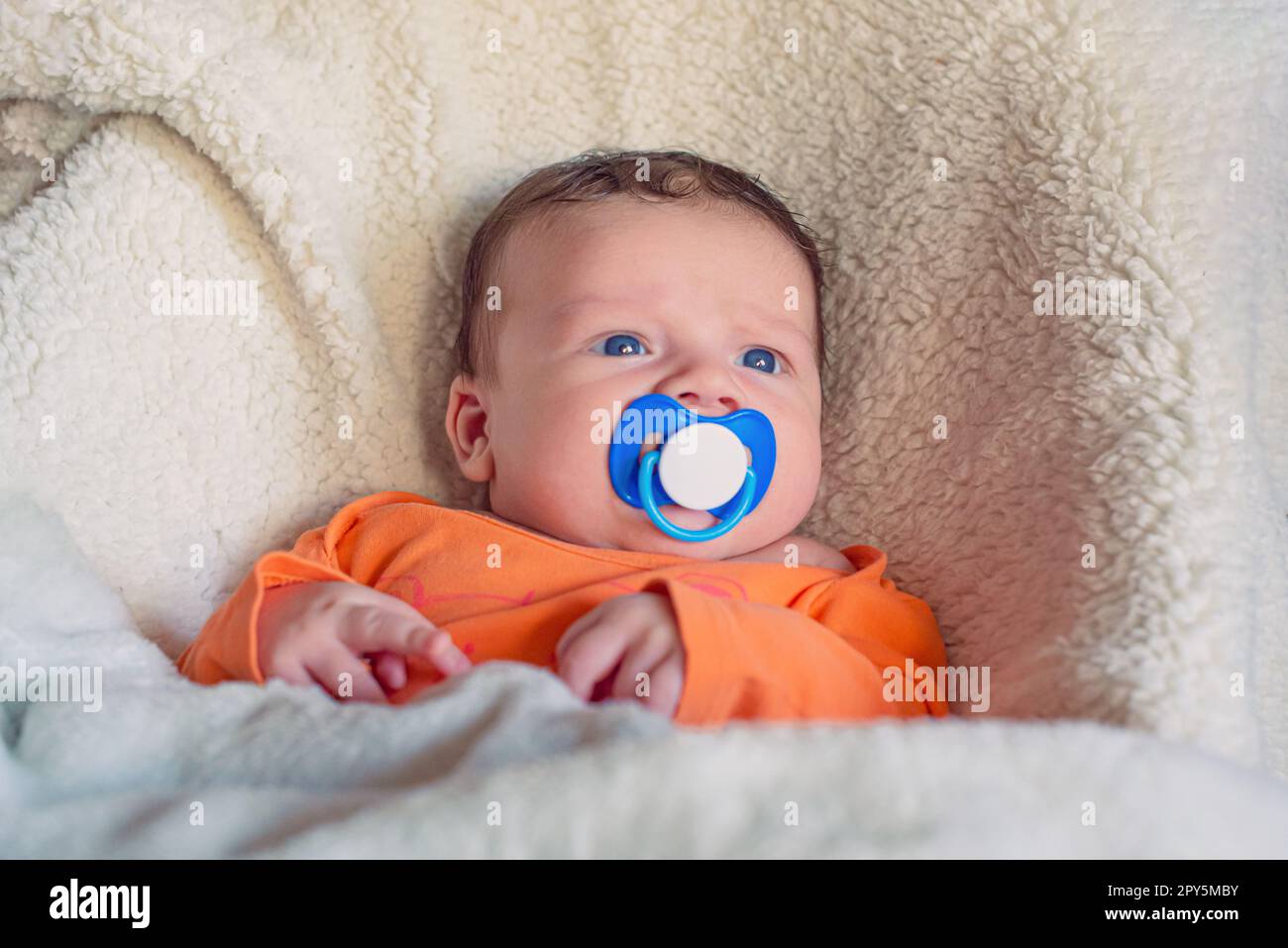 Baby sucking dummy hi-res stock photography and images - Alamy