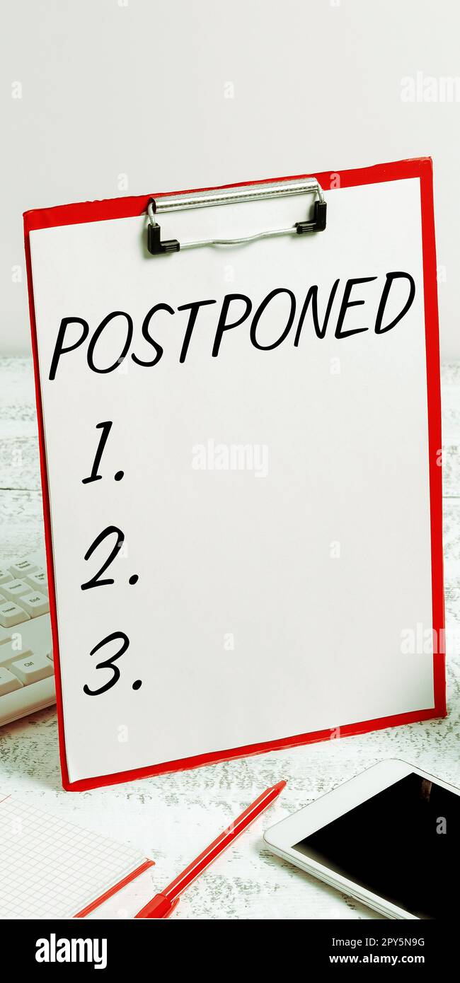 Sign displaying Postponed. Business approach to place later in order of ...