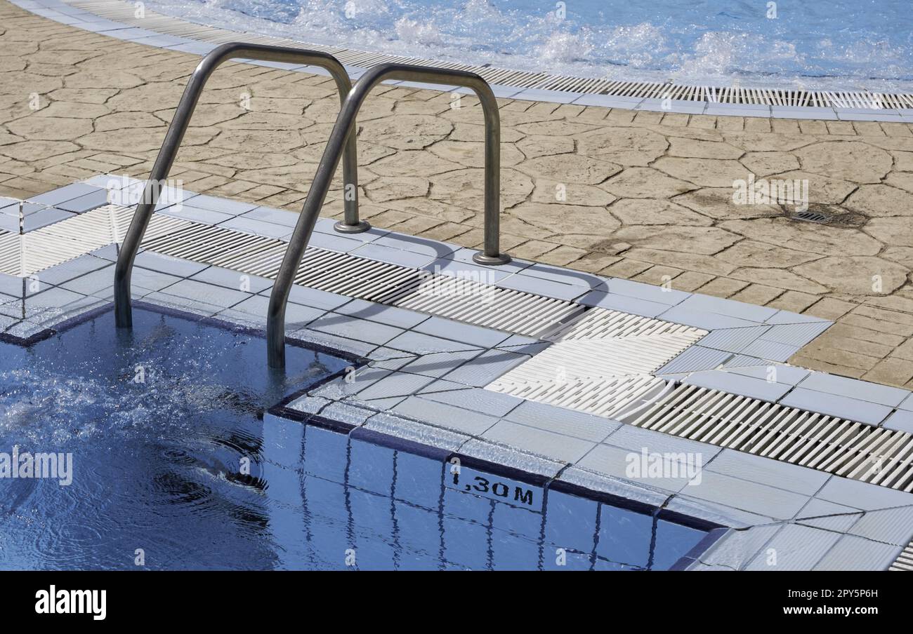 Metal pool ladder Stock Photo - Alamy