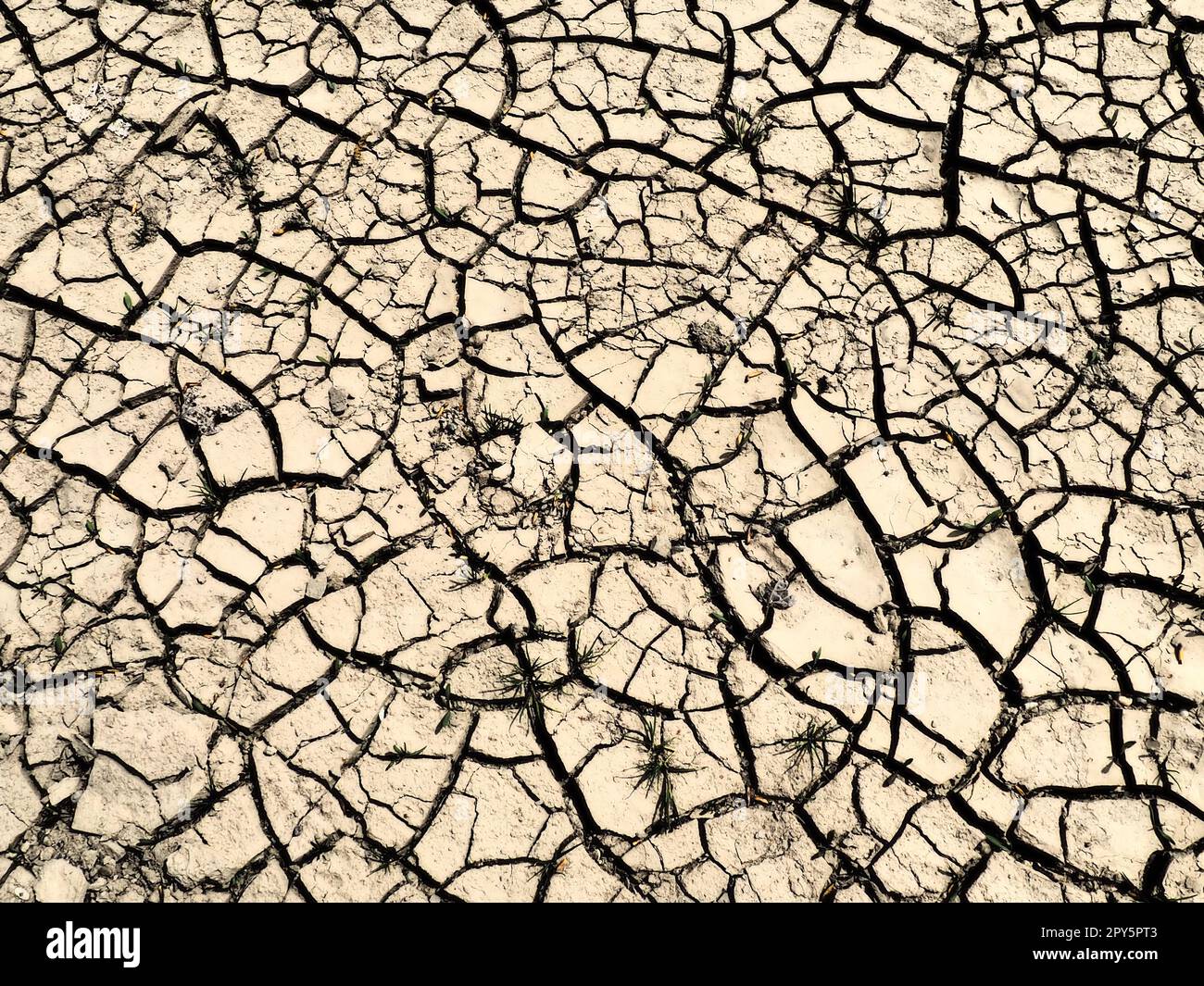 Deep cracks in the land as a symbol of hot climate and drought. Desert ...