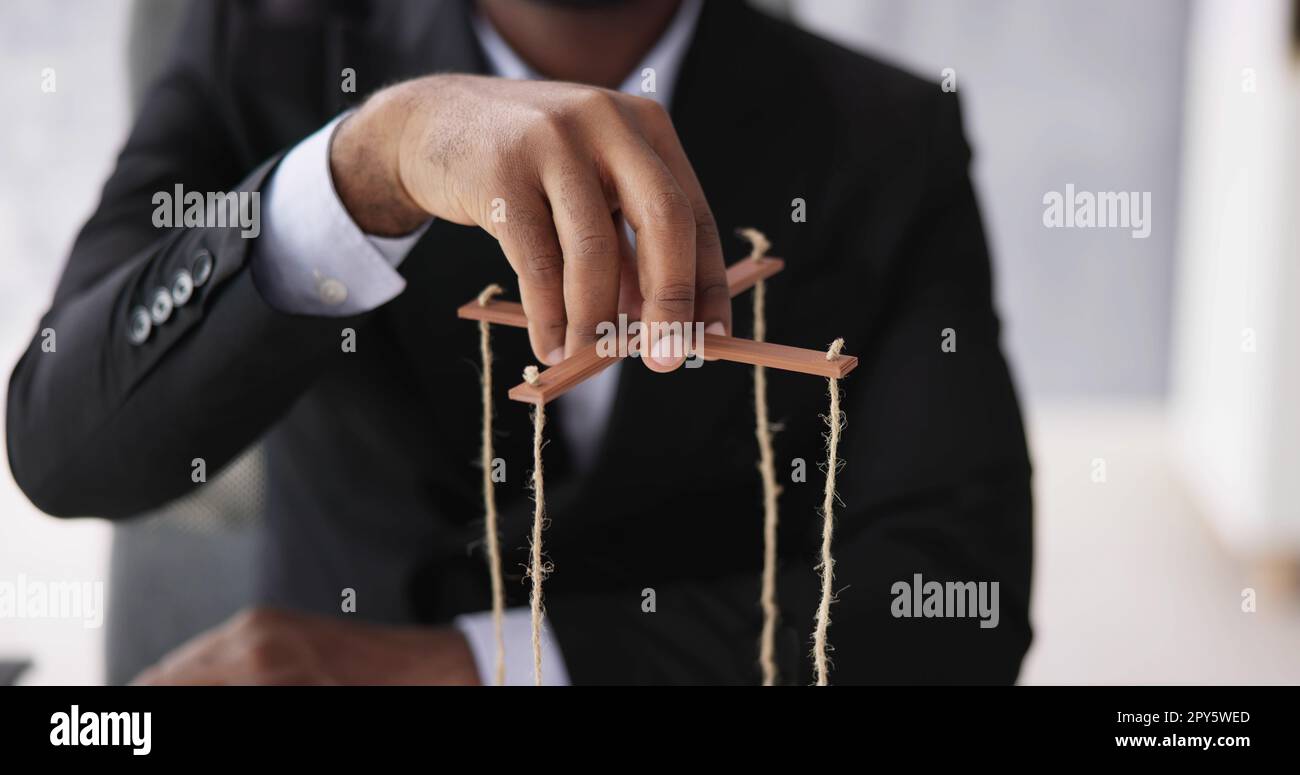 Marionette Manipulation With Hand Holding Puppet Strings Stock Photo - Alamy