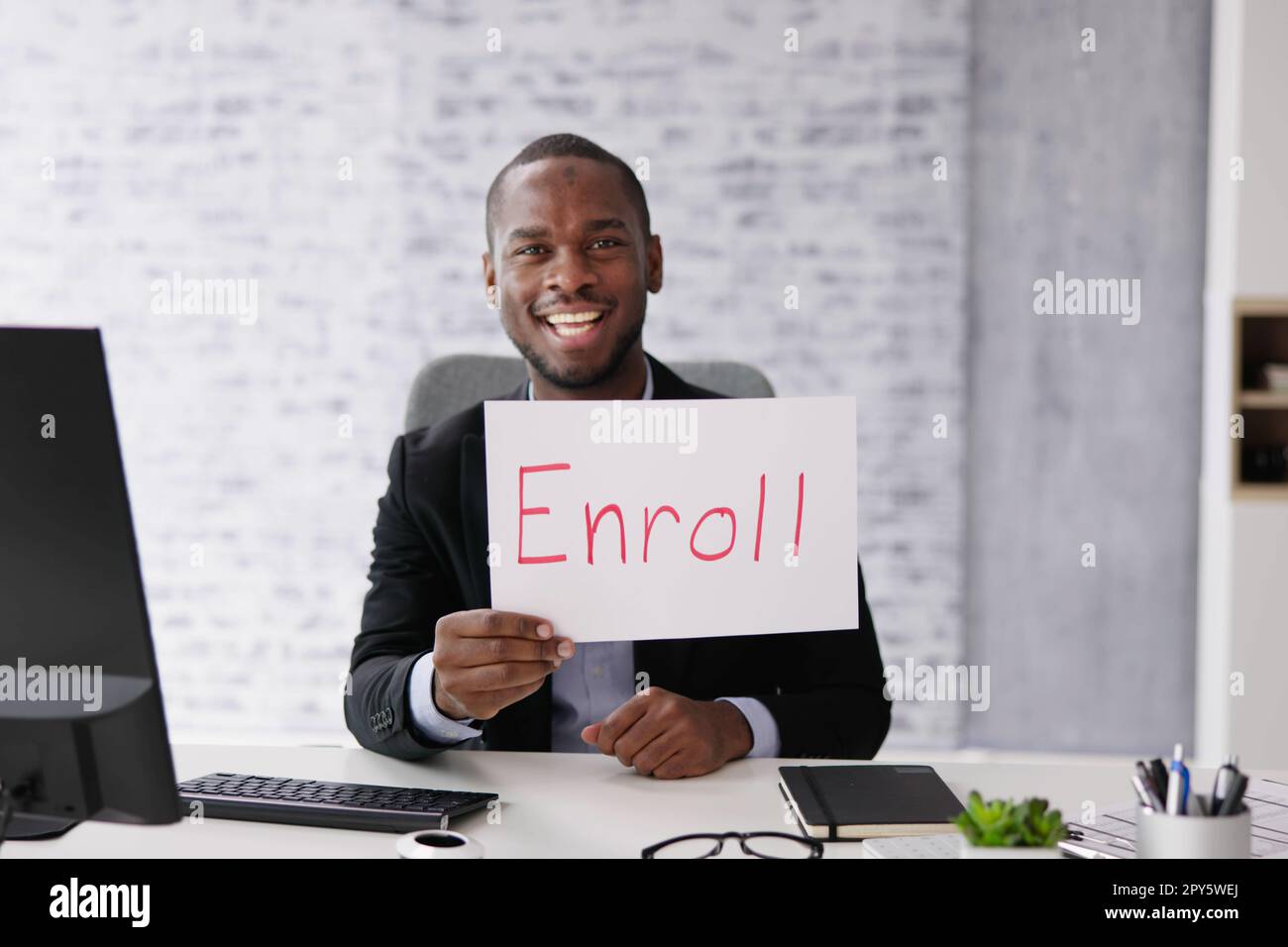 African American Man Holding Open Enrollment Registration Stock Photo ...