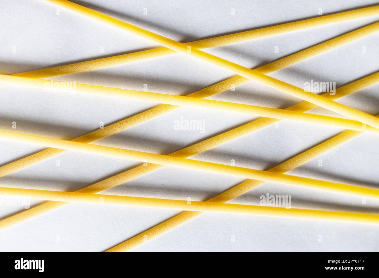 dry uncooked linguine pasta on white paper closeup Stock Photo - Alamy