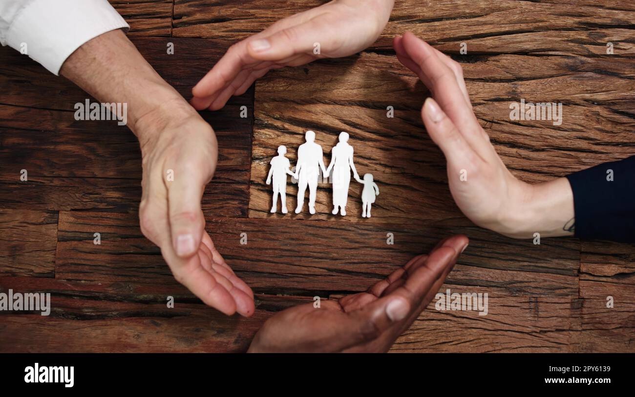 Group Of Hands Protecting Family Paper Cut Stock Photo - Alamy