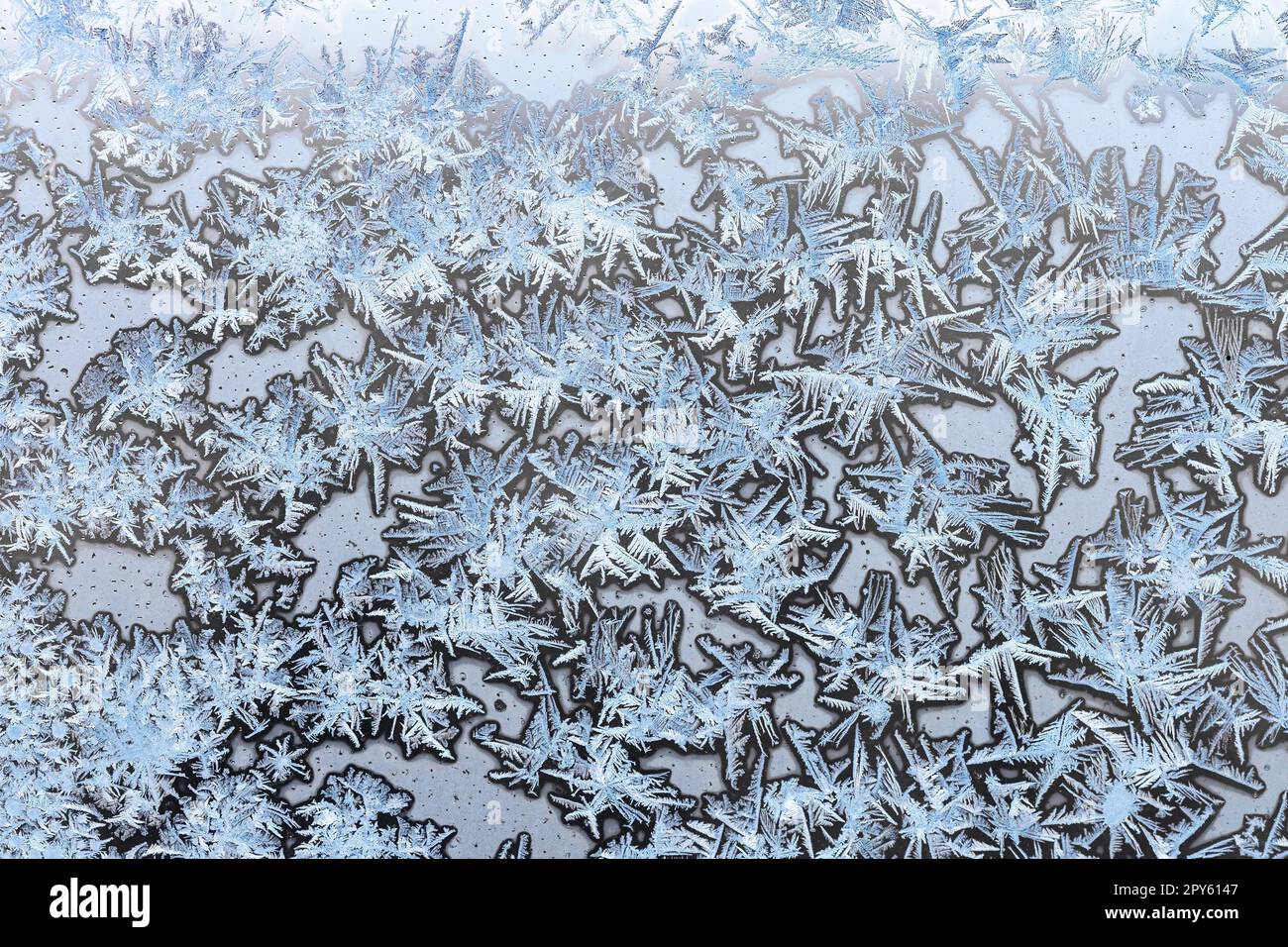 blue frozen ice on surface on home window close up Stock Photo - Alamy