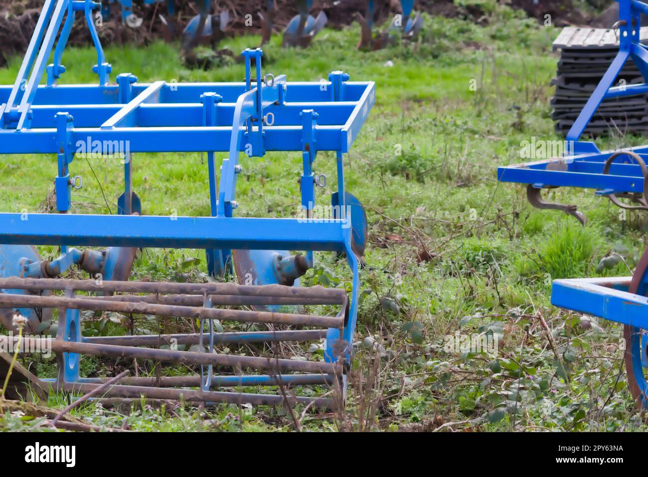 Blue heavy agricultural equipment like plow with sharp steel discs for ...