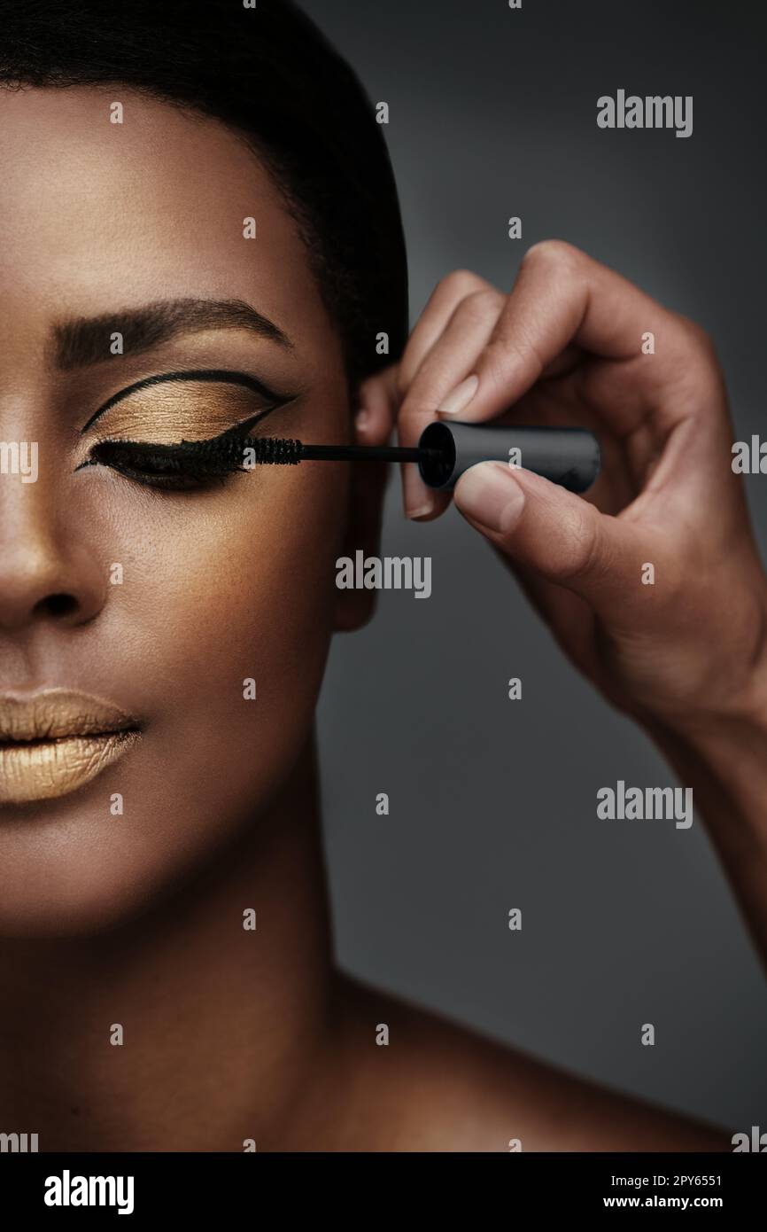 Mascara all your problems away. a beautiful young woman having her ...