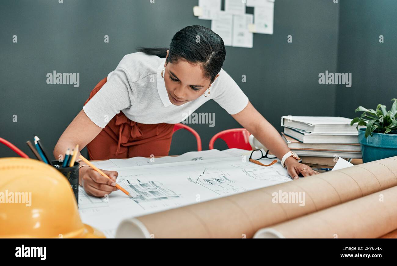 Shes busy producing master designs. a young architect working with ...
