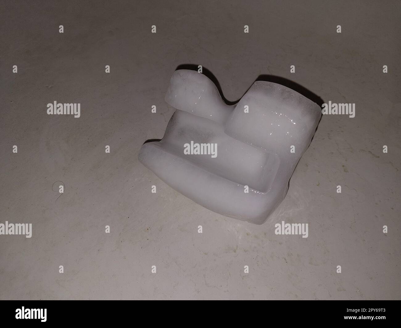 Ice falling from refrigerator freezer Stock Photo - Alamy