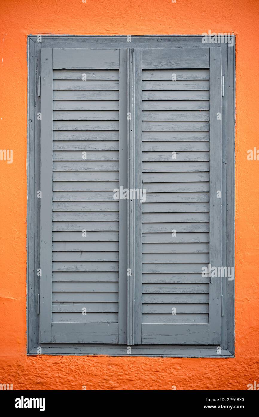 Orange wall with vintage window blinds Stock Photo - Alamy