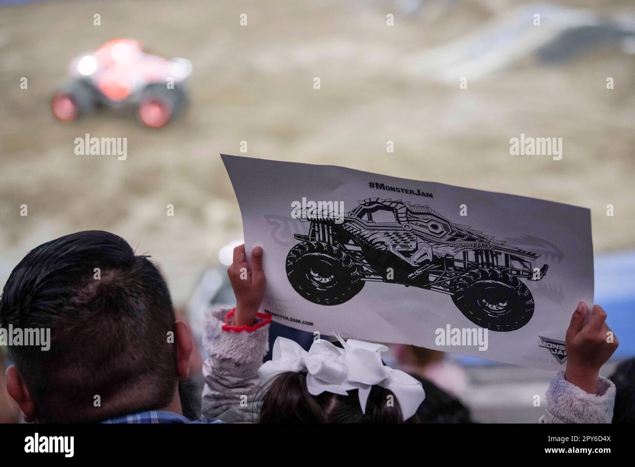 A Monster Jam fan holds up a sign of ThunderROARous as the truck ...