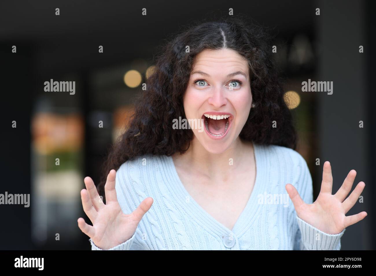 Surprised woman looking at camera Stock Photo - Alamy