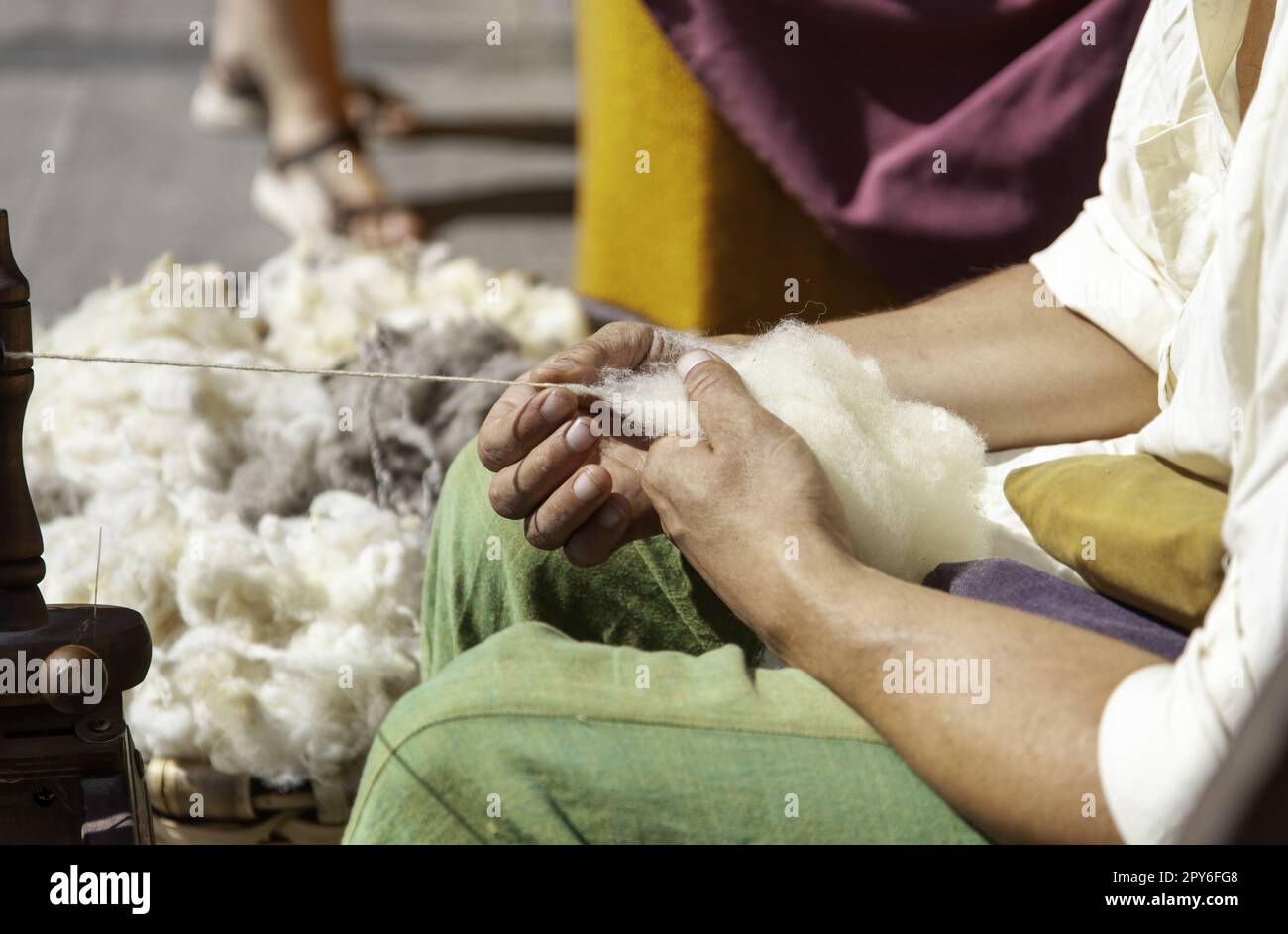 Hands spinning wool Stock Photo - Alamy