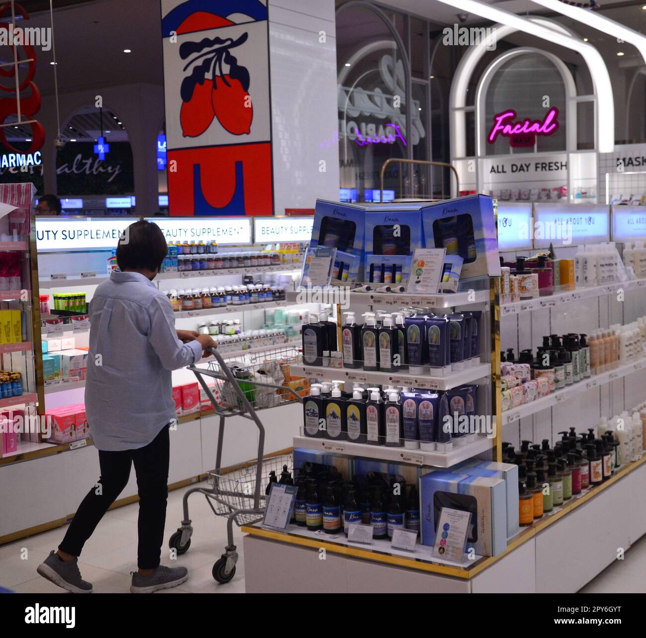 Woman pushes shopping trolley in skin care and beauty aisle at Siam ...
