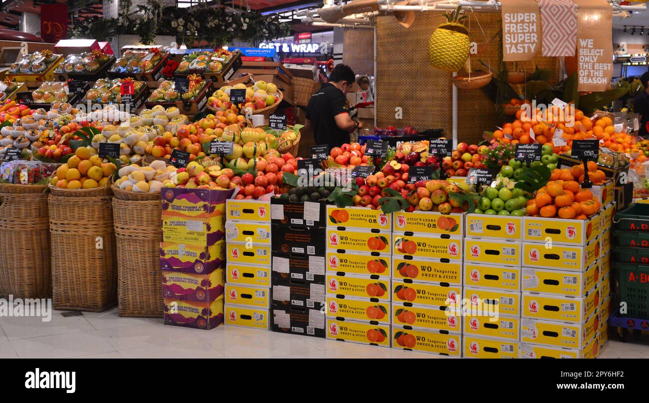 Staff member behind counter at fruit stall at the food supermarket at ...