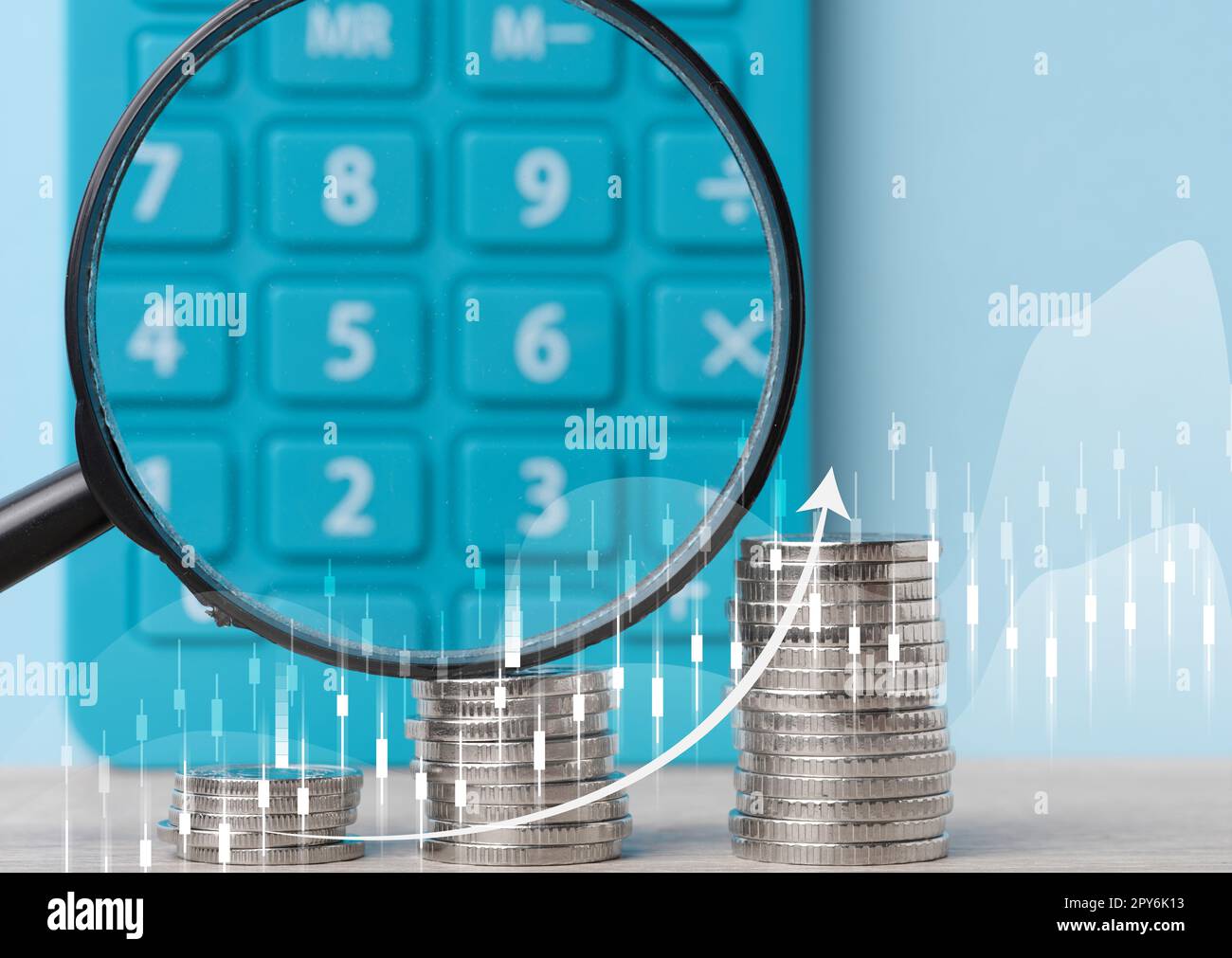 A stack of metallic coins and a chart with growing rates. High income ...