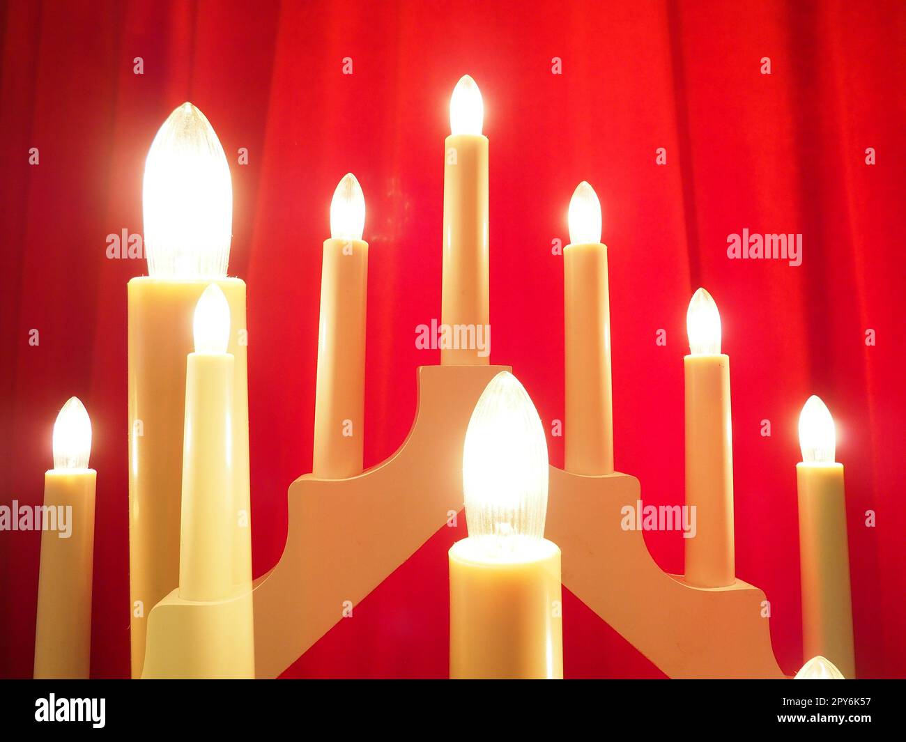 Schwibbogen arch luminaire in the form of a triangular candlestick. Red ...
