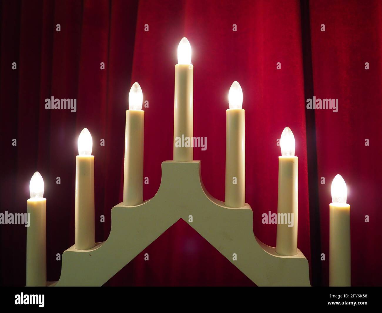 Schwibbogen arch luminaire in the form of a triangular candlestick. Red ...