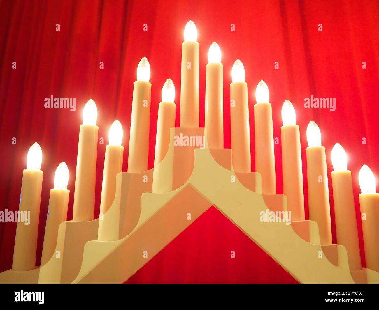 Schwibbogen arch luminaire in the form of a triangular candlestick. Red ...