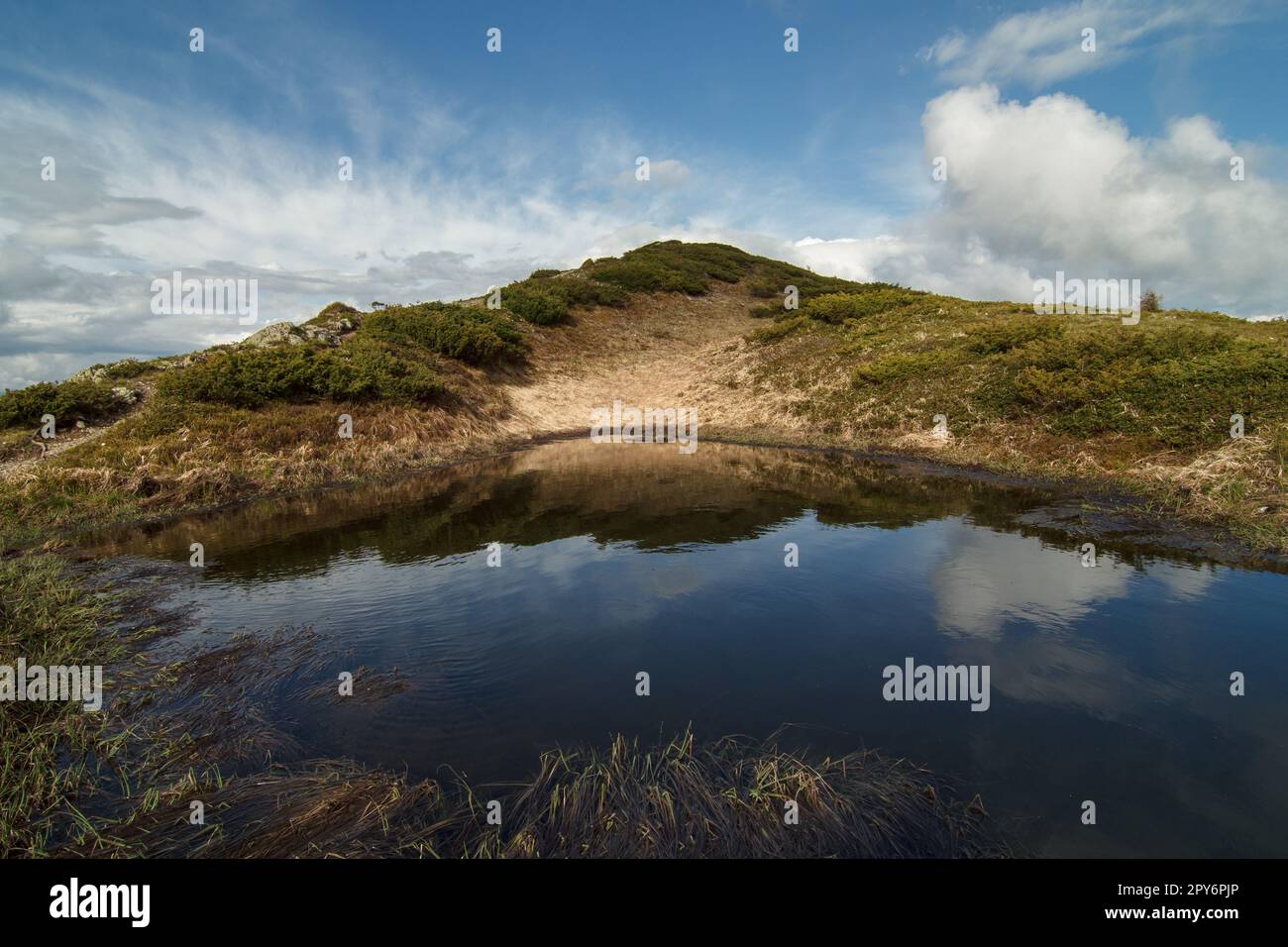 Lake near steep slope landscape photo Stock Photo - Alamy