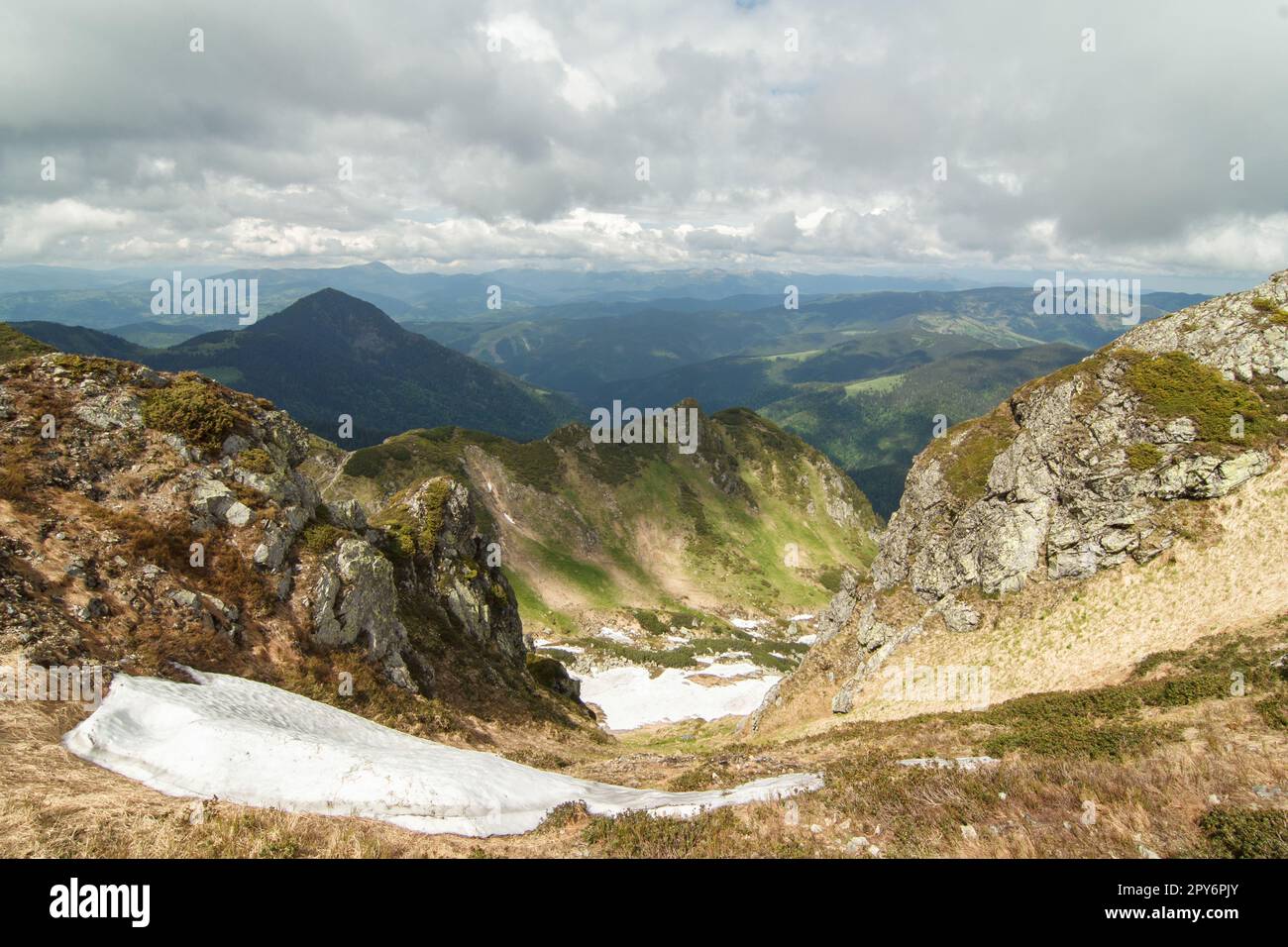 Melting snow in rocky mountains landscape photo Stock Photo - Alamy