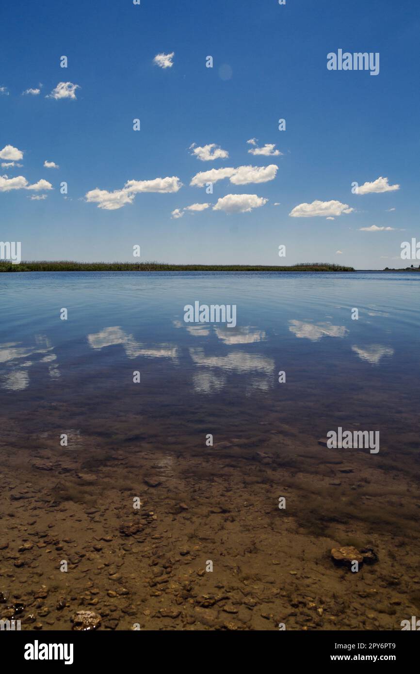 Clouds reflect in water landscape photo Stock Photo - Alamy