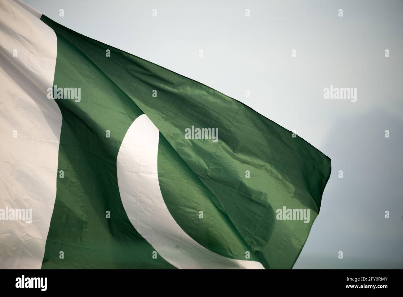 The national flag of Pakistan flying in the blue sky with clouds Stock ...