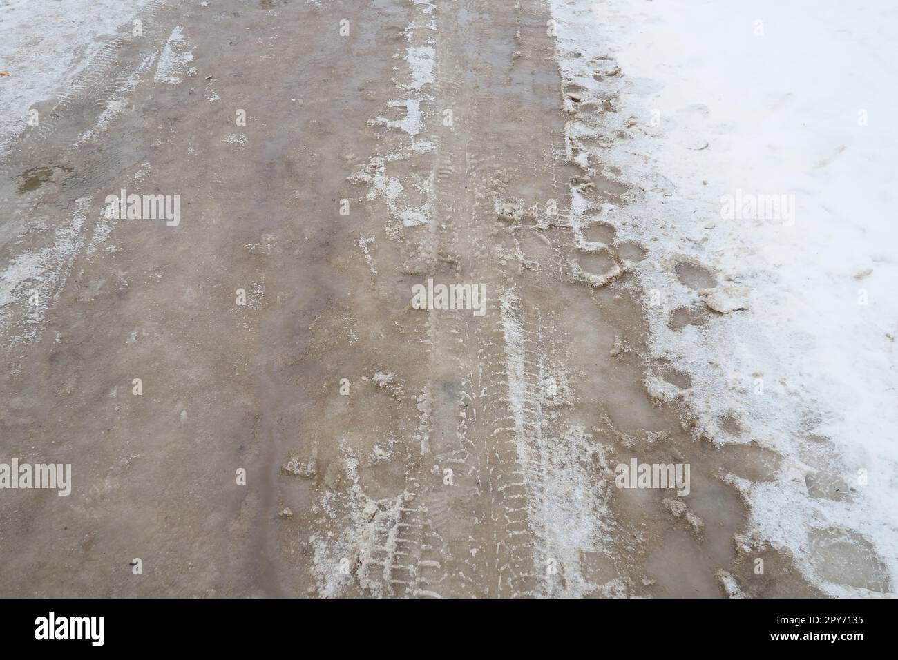 Snow, ice, slush and winter mud at a pedestrian crossing. The air ...