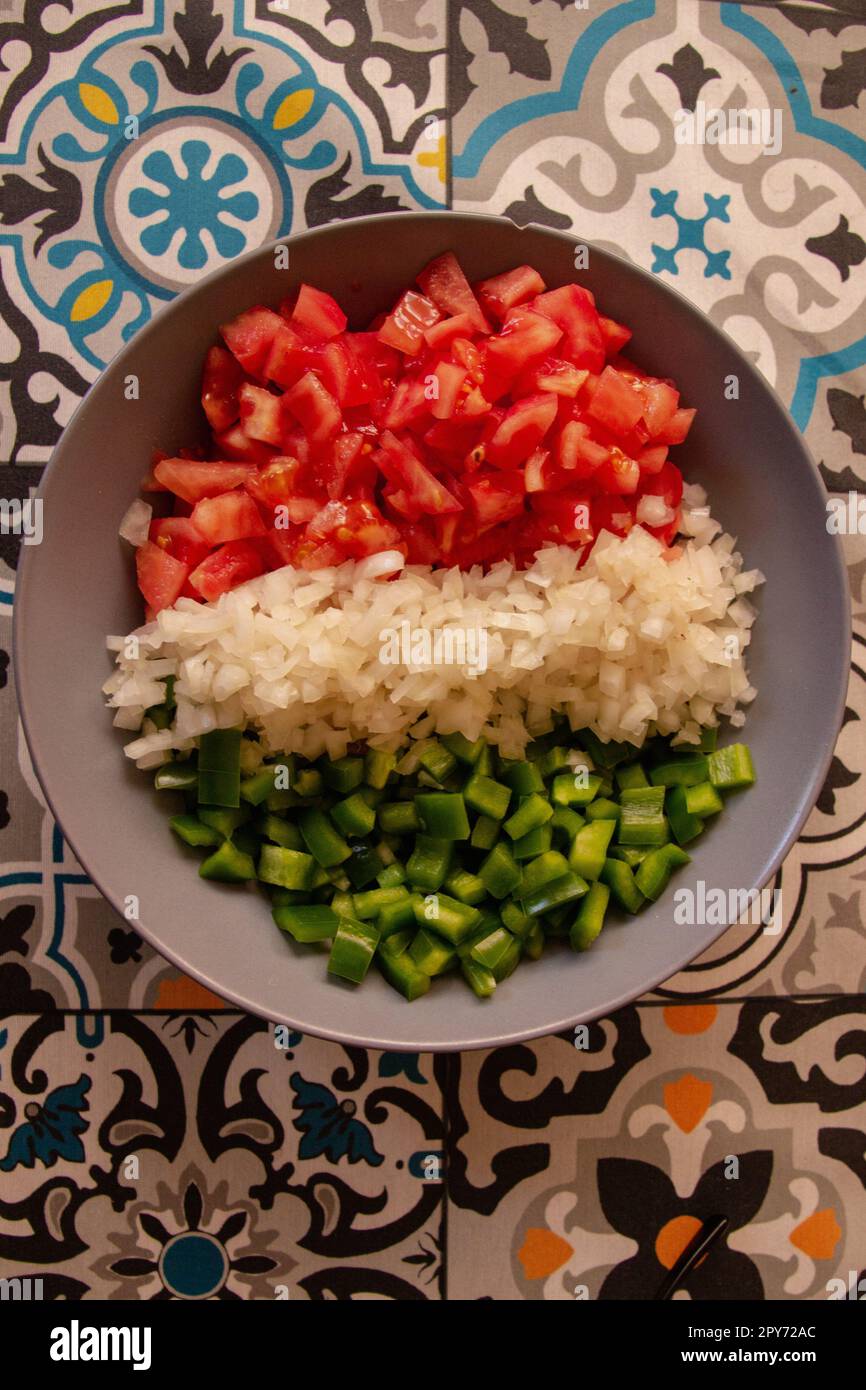 Tomato, green pepper and onion cut into dice in a bowl Stock Photo - Alamy