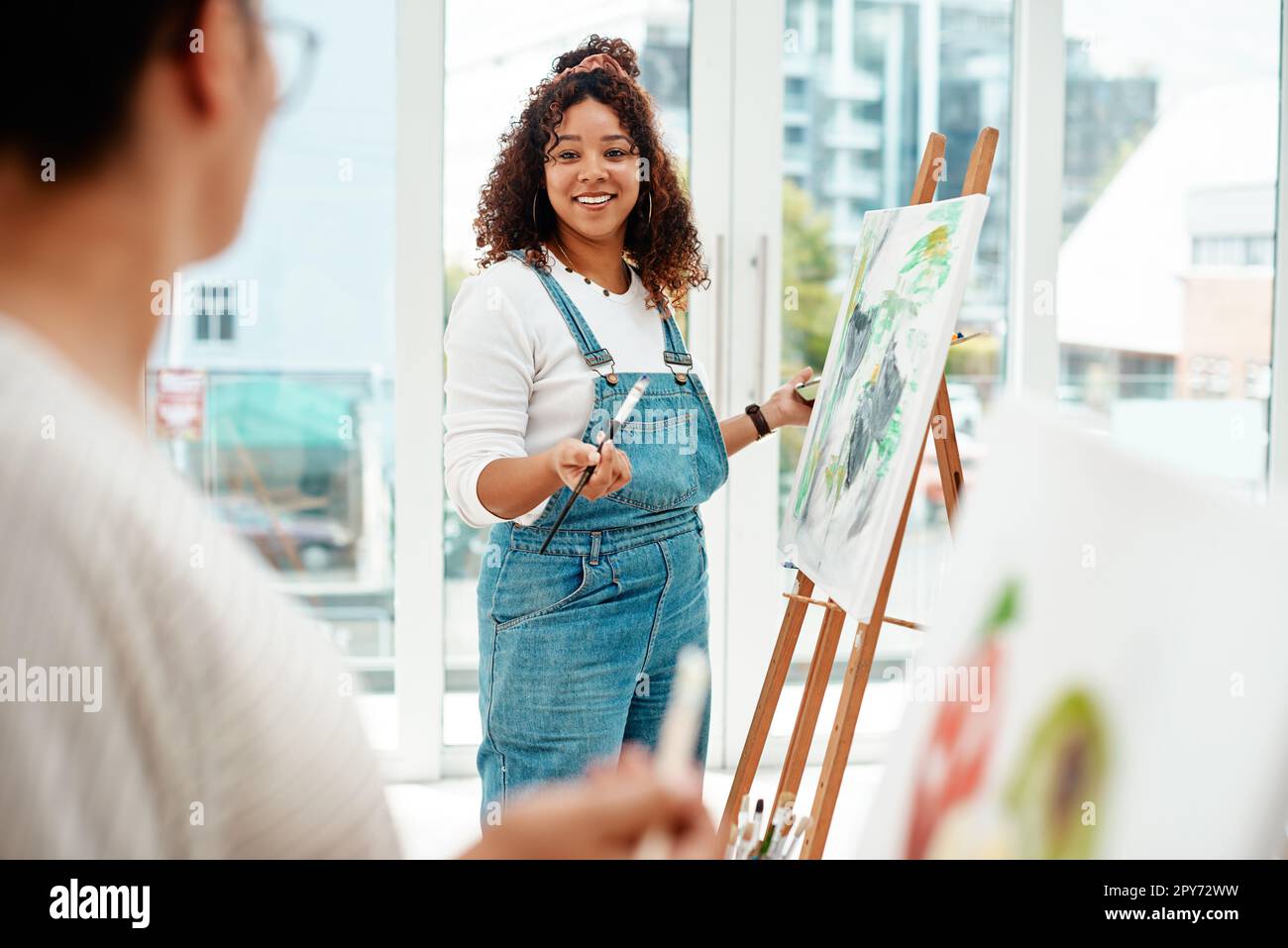 Friends that paint together, stick together. an attractive young woman ...