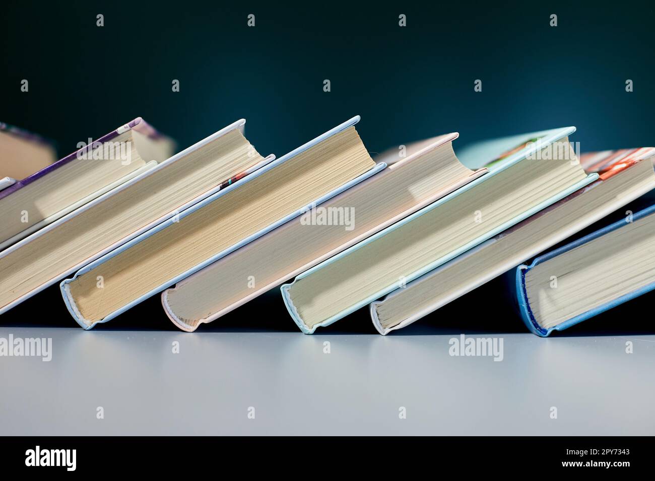 Stack of books in a row with on dark background, World book day ...