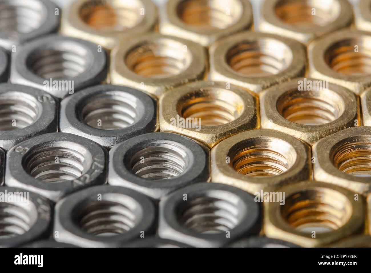 Metallic hex nuts layed out in a hexagonal pattern Stock Photo - Alamy