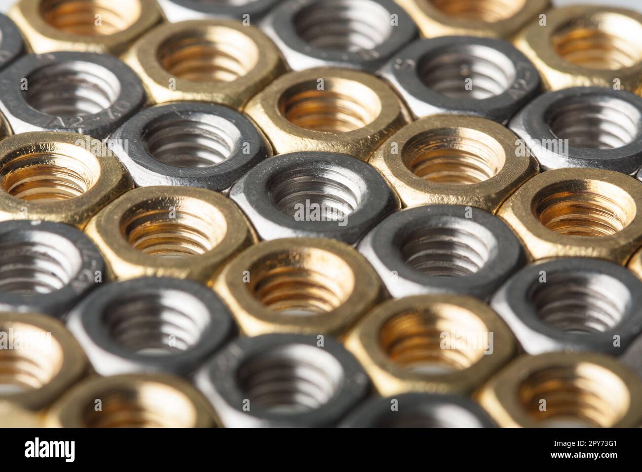 Metallic hex nuts layed out in a hexagonal pattern Stock Photo - Alamy