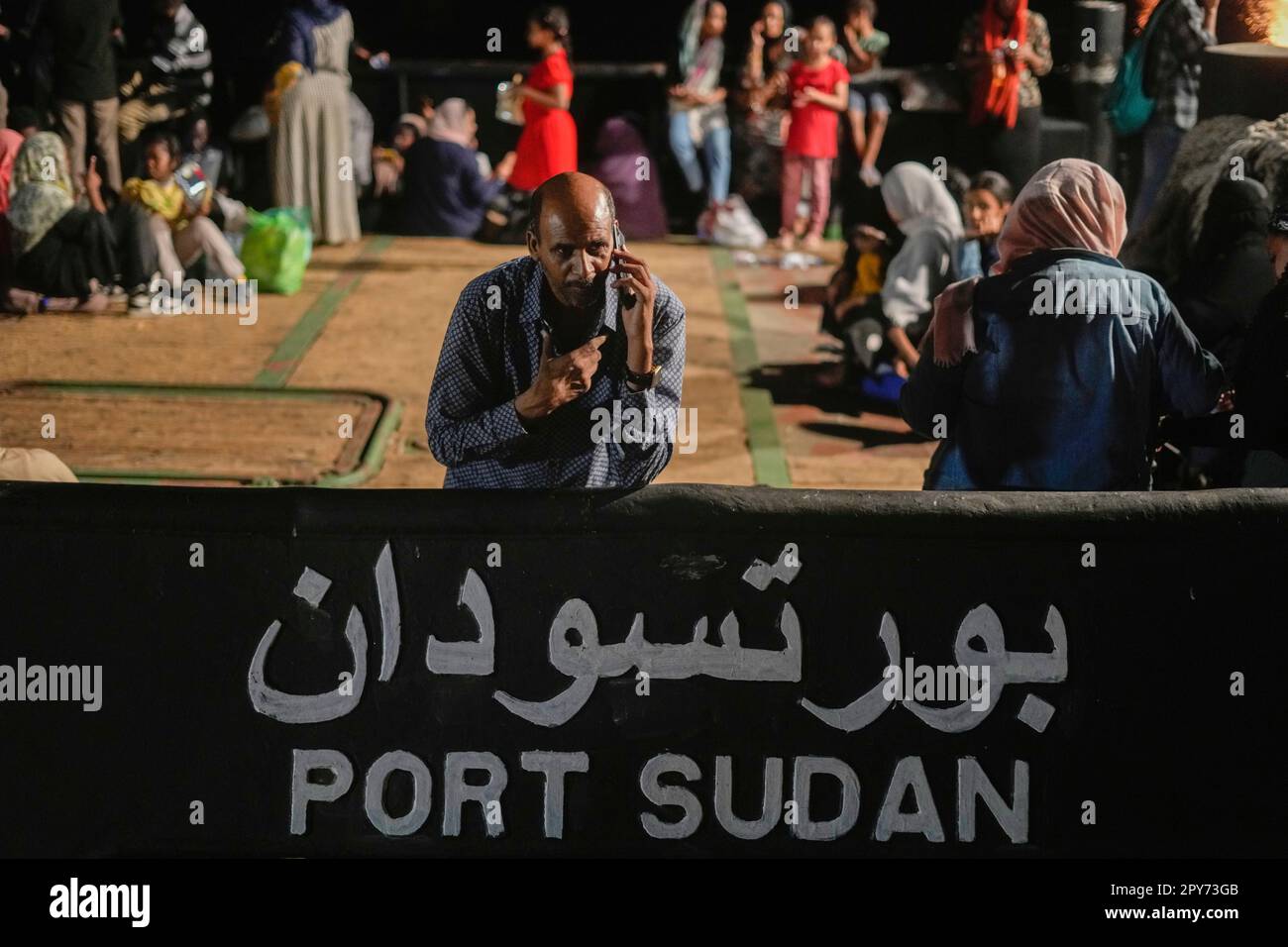A Sudanese evacuee waits at Port Sudan before boarding a Saudi military ...