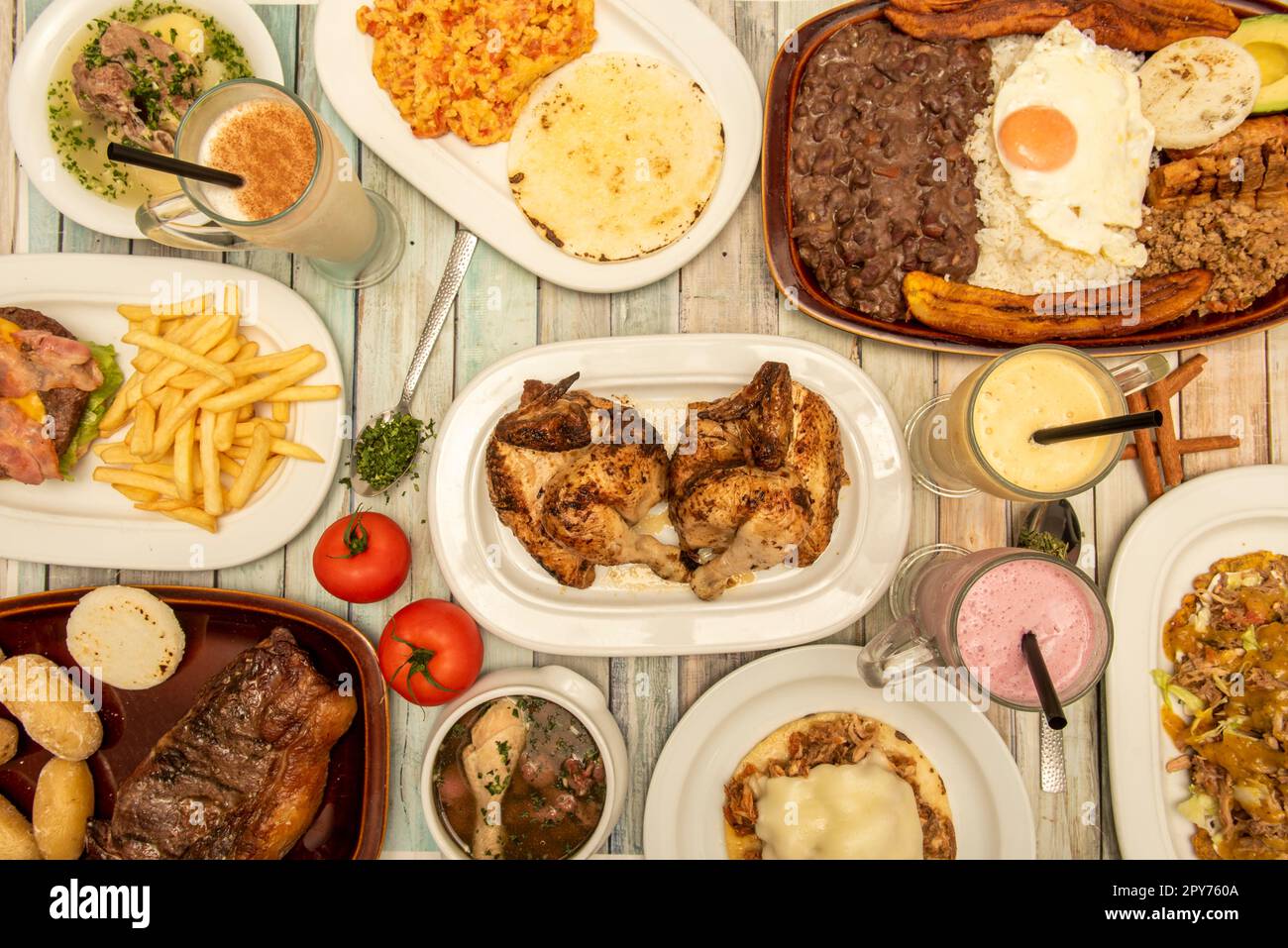 A large set of typical Colombian food dishes with juices and grilled ...