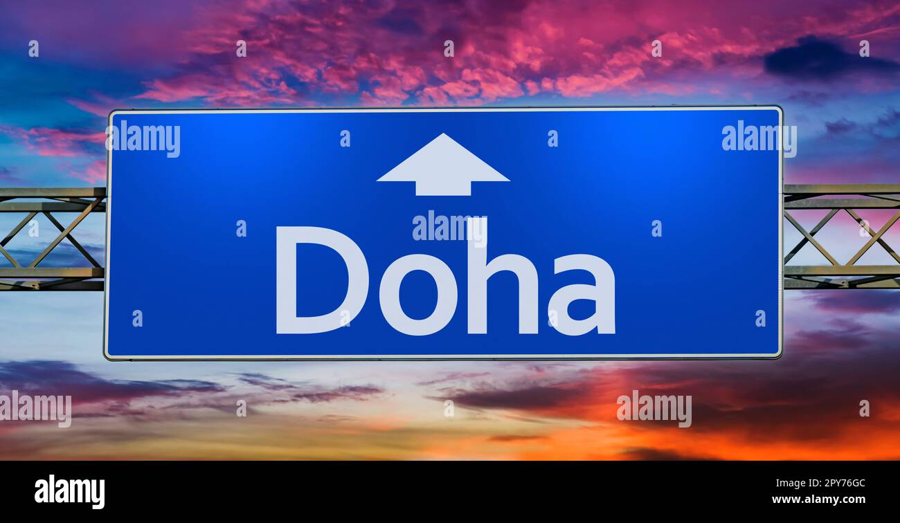 Road sign indicating direction to the city of Doha Stock Photo - Alamy
