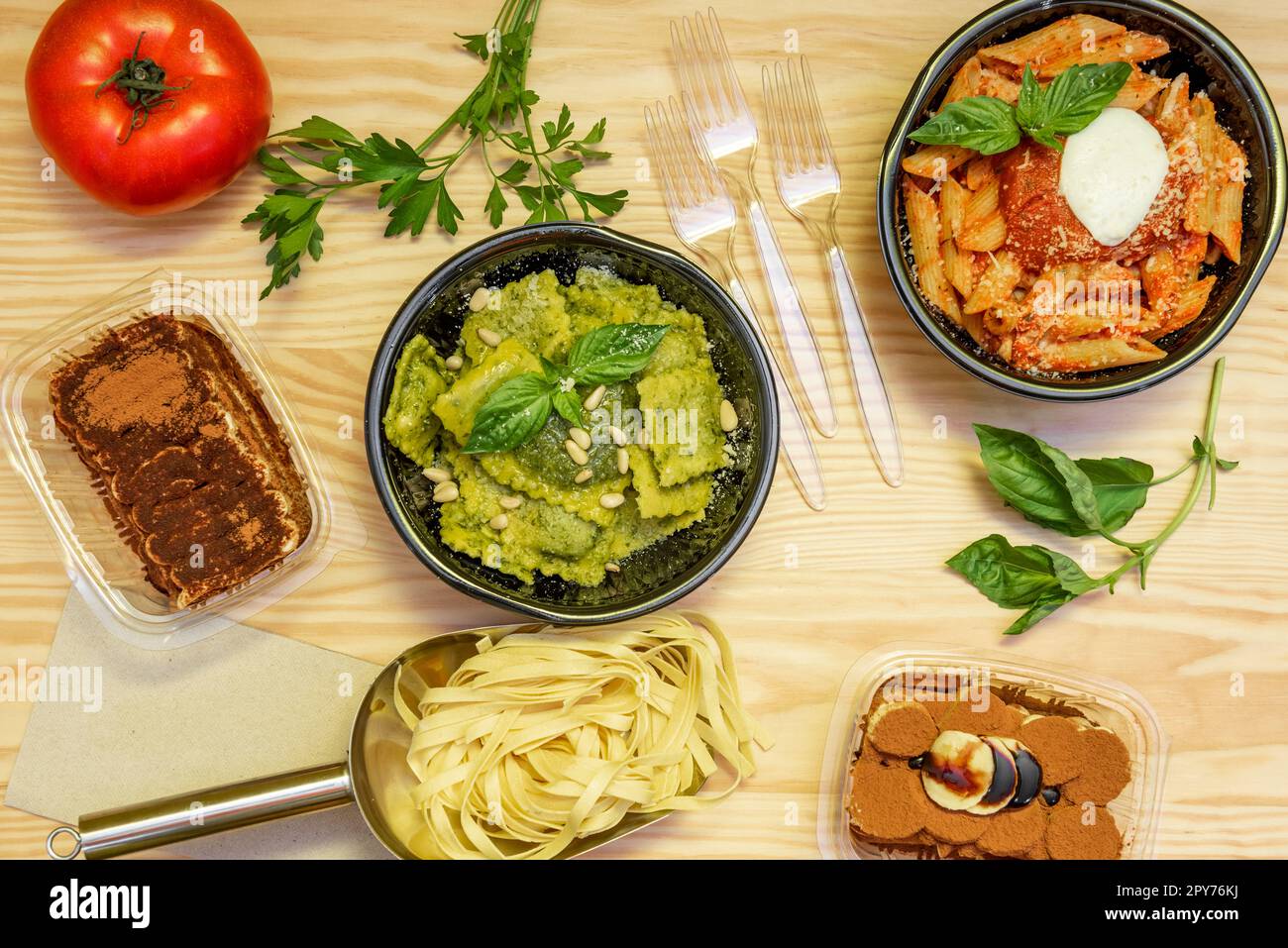 A few containers full of typical Italian pasta and desserts ready for ...