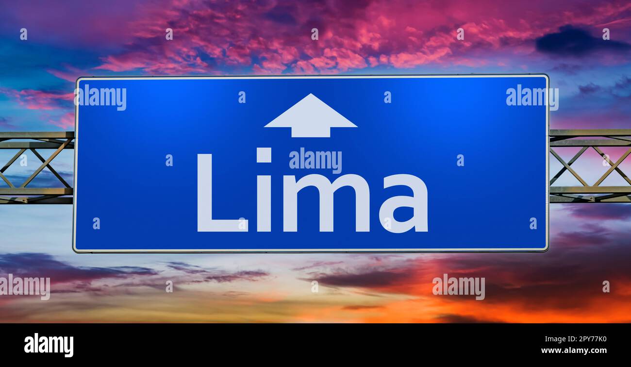 Road sign indicating direction to the city of Lima Stock Photo - Alamy