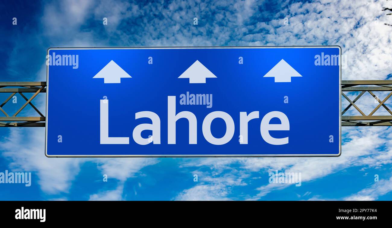 Road sign indicating direction to the city of Lahore Stock Photo - Alamy