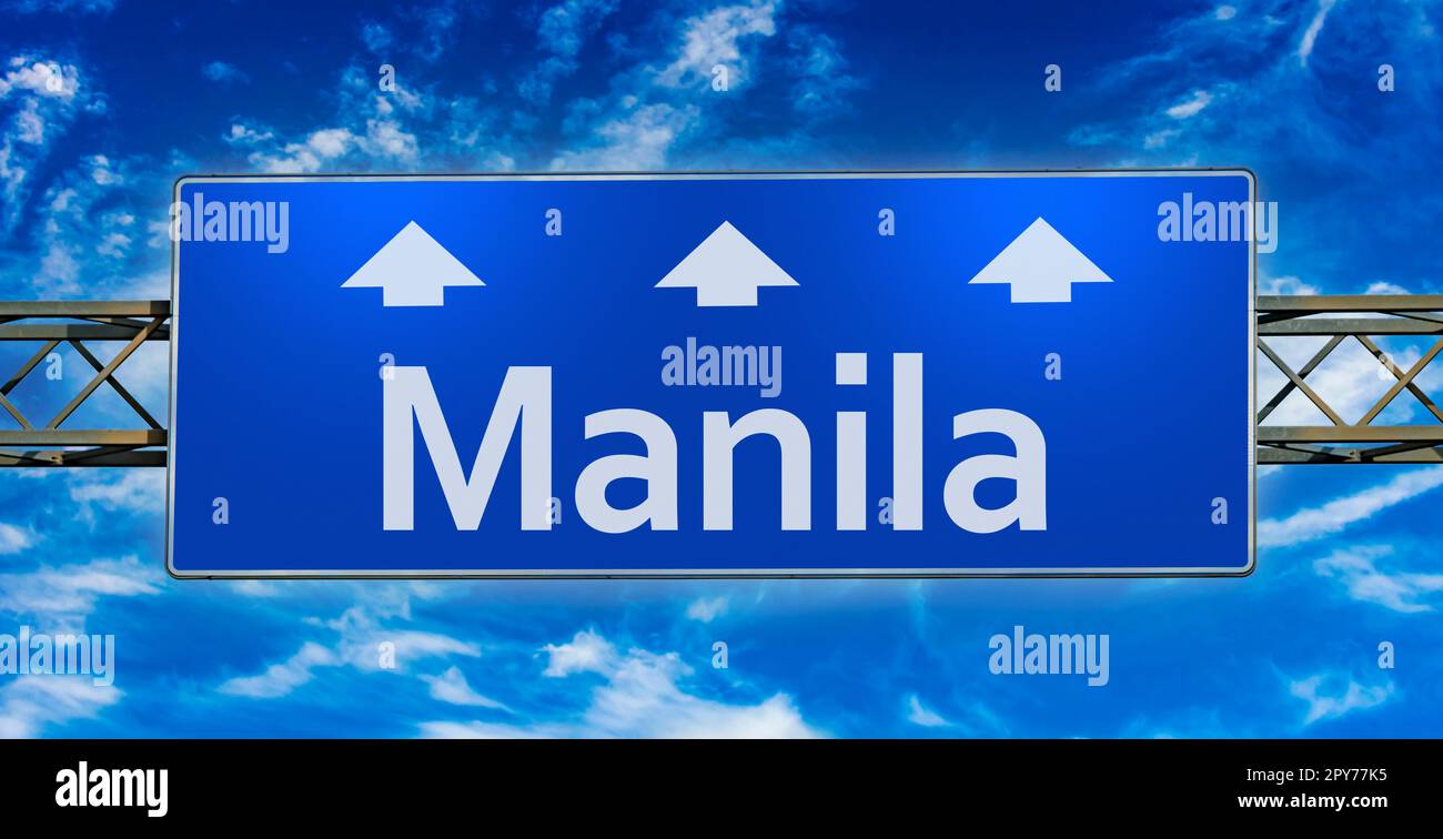 Road sign indicating direction to the city of Manila Stock Photo - Alamy