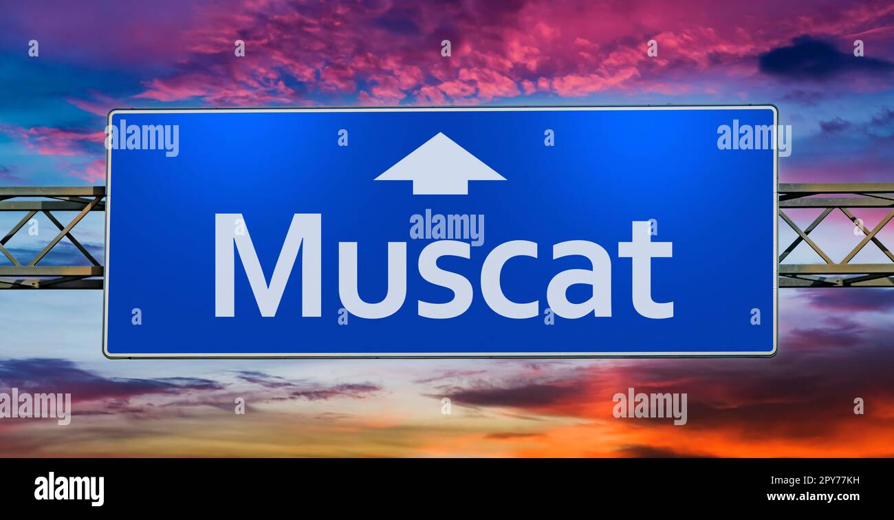 Road sign indicating direction to the city of Muscat Stock Photo - Alamy