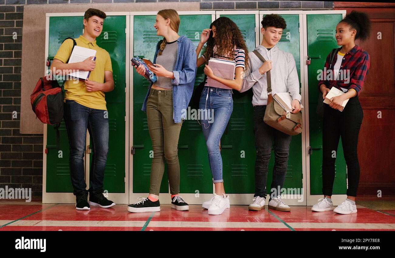 Some banter before class. a group of cheerful young school kids talking ...