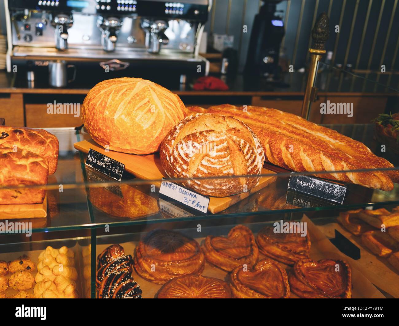 Bakery display featuring an array of freshly-baked artisanal breads in ...