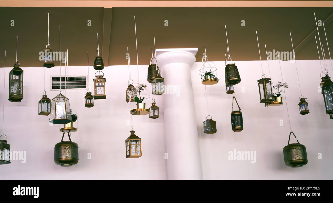 Group of metallic lanterns hanging from the ceiling in an interior room ...
