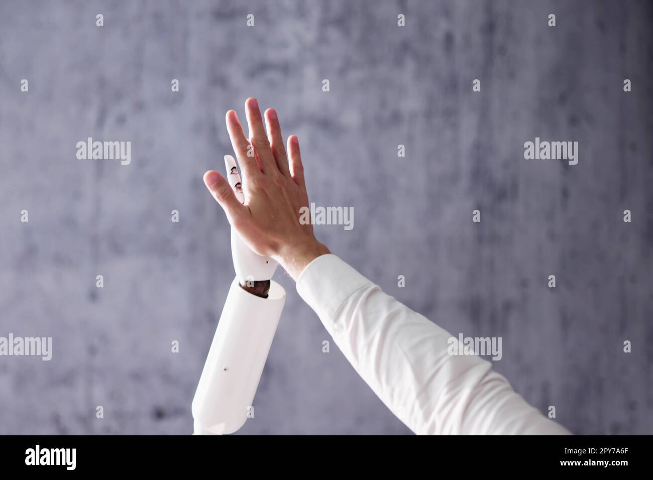 Robot And Man Giving High Five Against Gray Stock Photo - Alamy