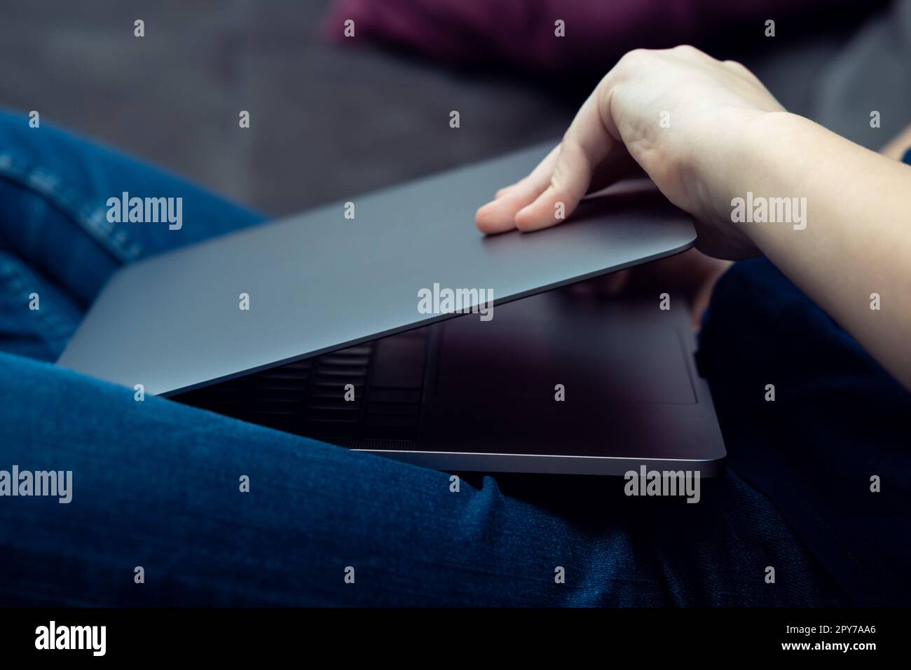 Unrecognizable male hands opening laptop cover on knees. Portable ...