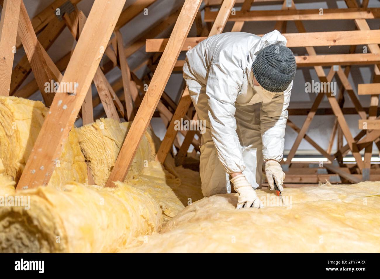 thermal insulation of roof spaces with glass wool Stock Photo - Alamy
